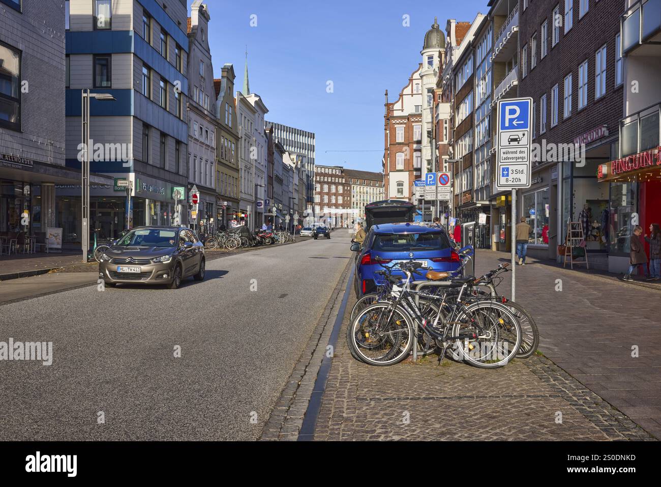 Parking lane with cars and bicycles, general development ...