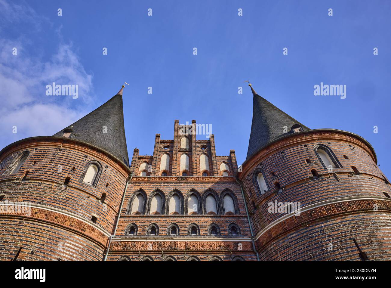 City gate, historic brick building, round towers with slate roof, gable ...