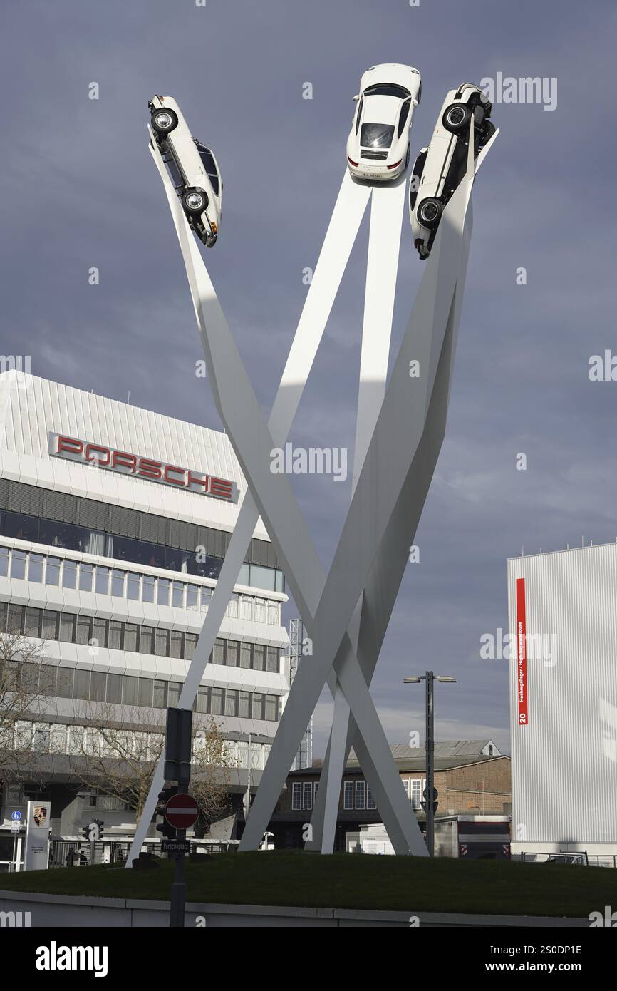 Modern sculpture with three cars in front of an architectural building ...