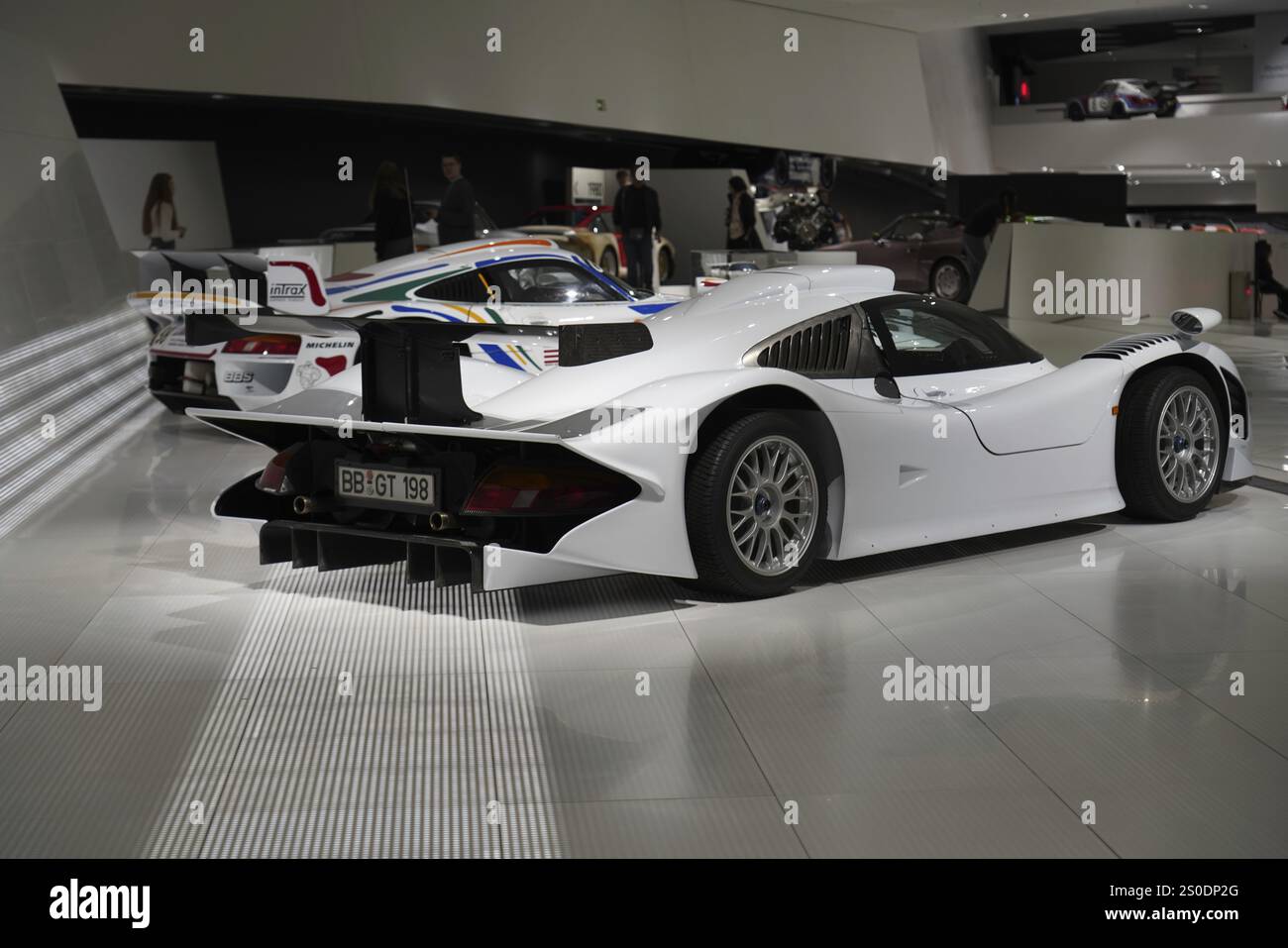 White racing car with aerodynamic features in an exhibition environment ...