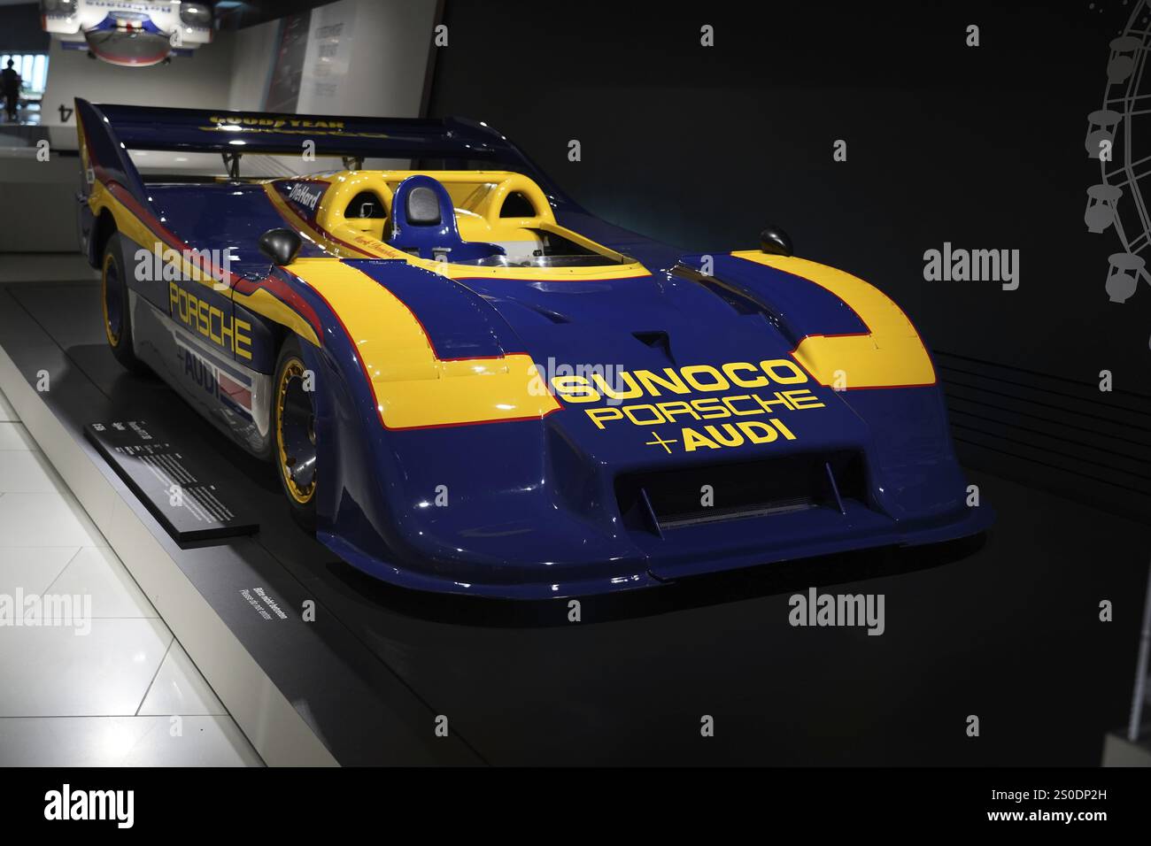 Blue and yellow Sunoco Porsche Audi racing car in an exhibition room ...