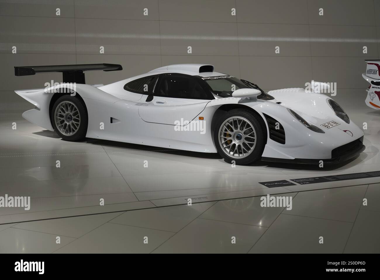 Modern white racing car exhibited in a bright room, New Porsche Museum ...