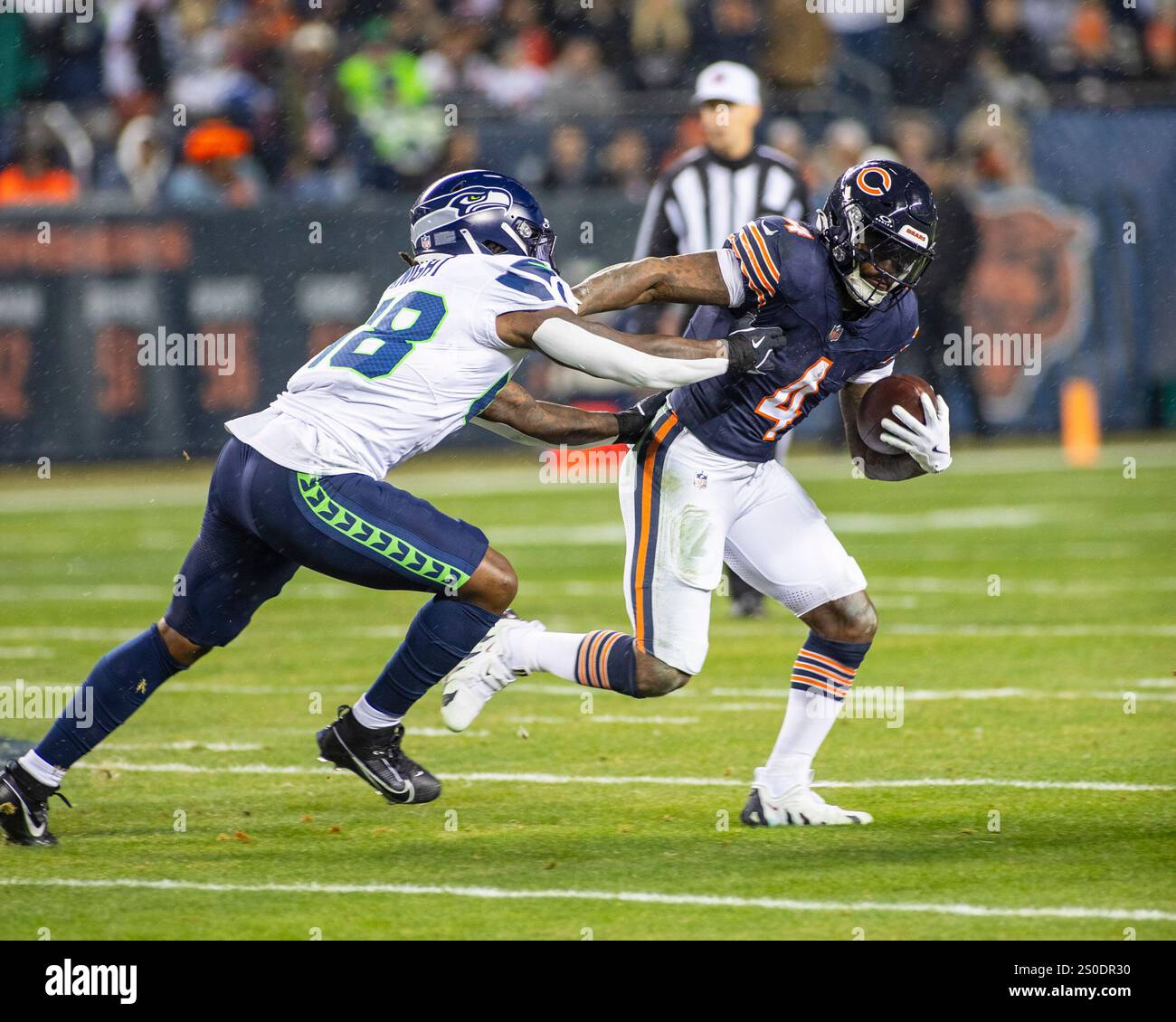 Chicago Bears D'Andre Swift (4) is chased by Seattle Seahawks Tyrice ...
