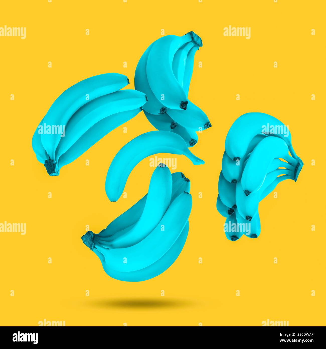 Light blue bananas in air on yellow background Stock Photo - Alamy
