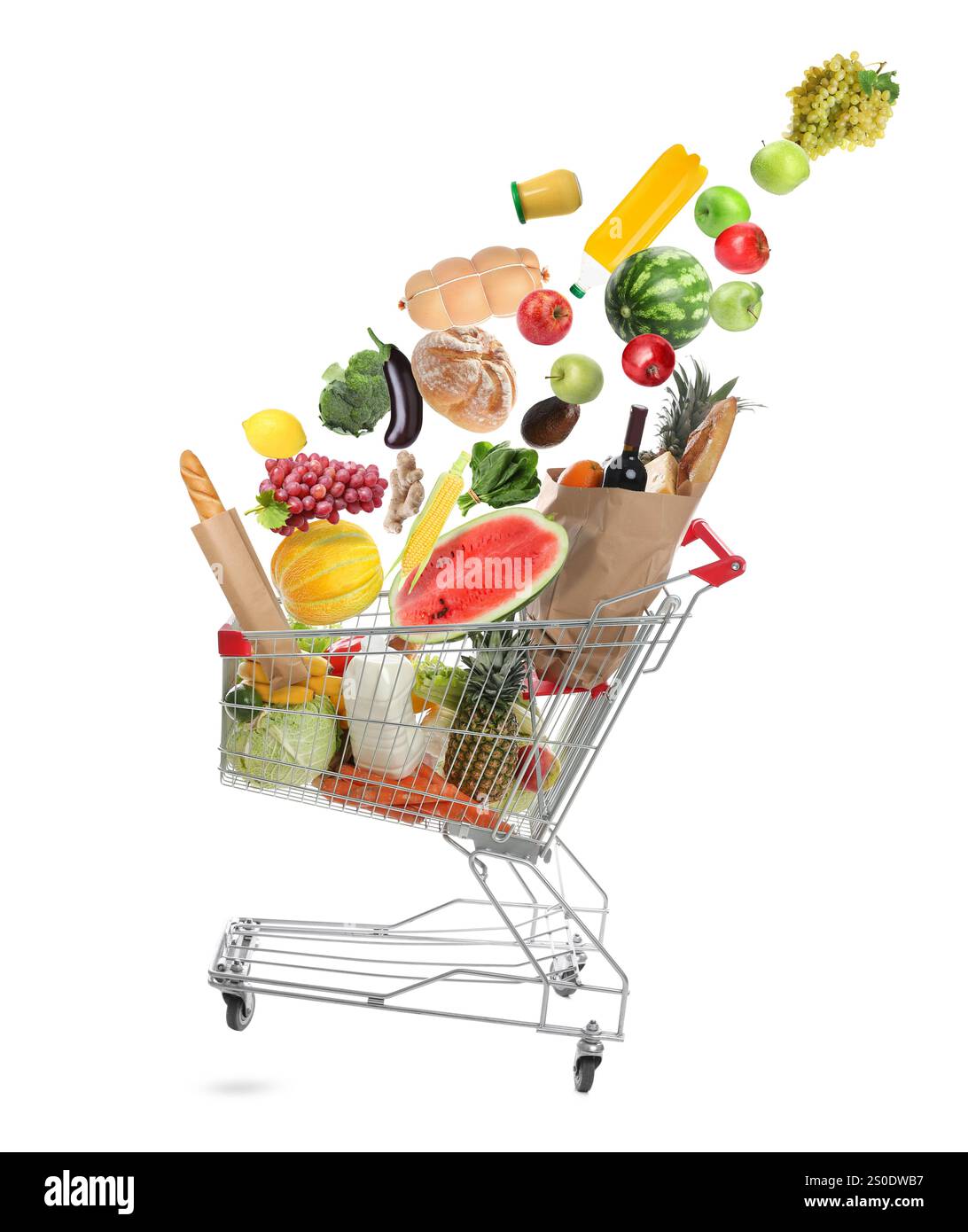 Many different products falling into shopping cart on white background ...