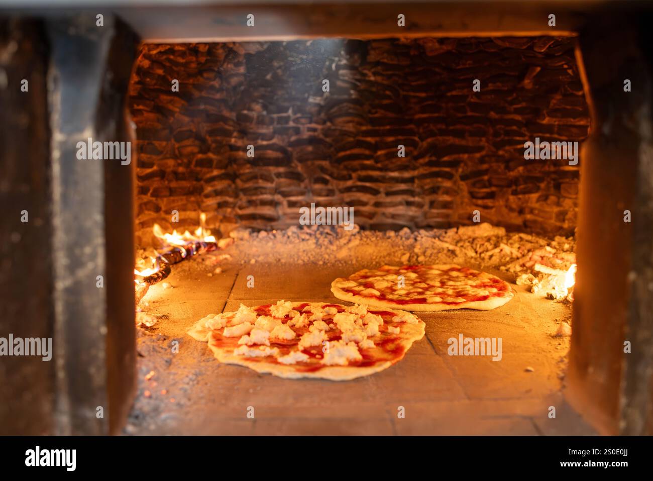 Traditional Pizzas Baking Inside a Rustic Wood-Fired Oven Stock Photo - Alamy