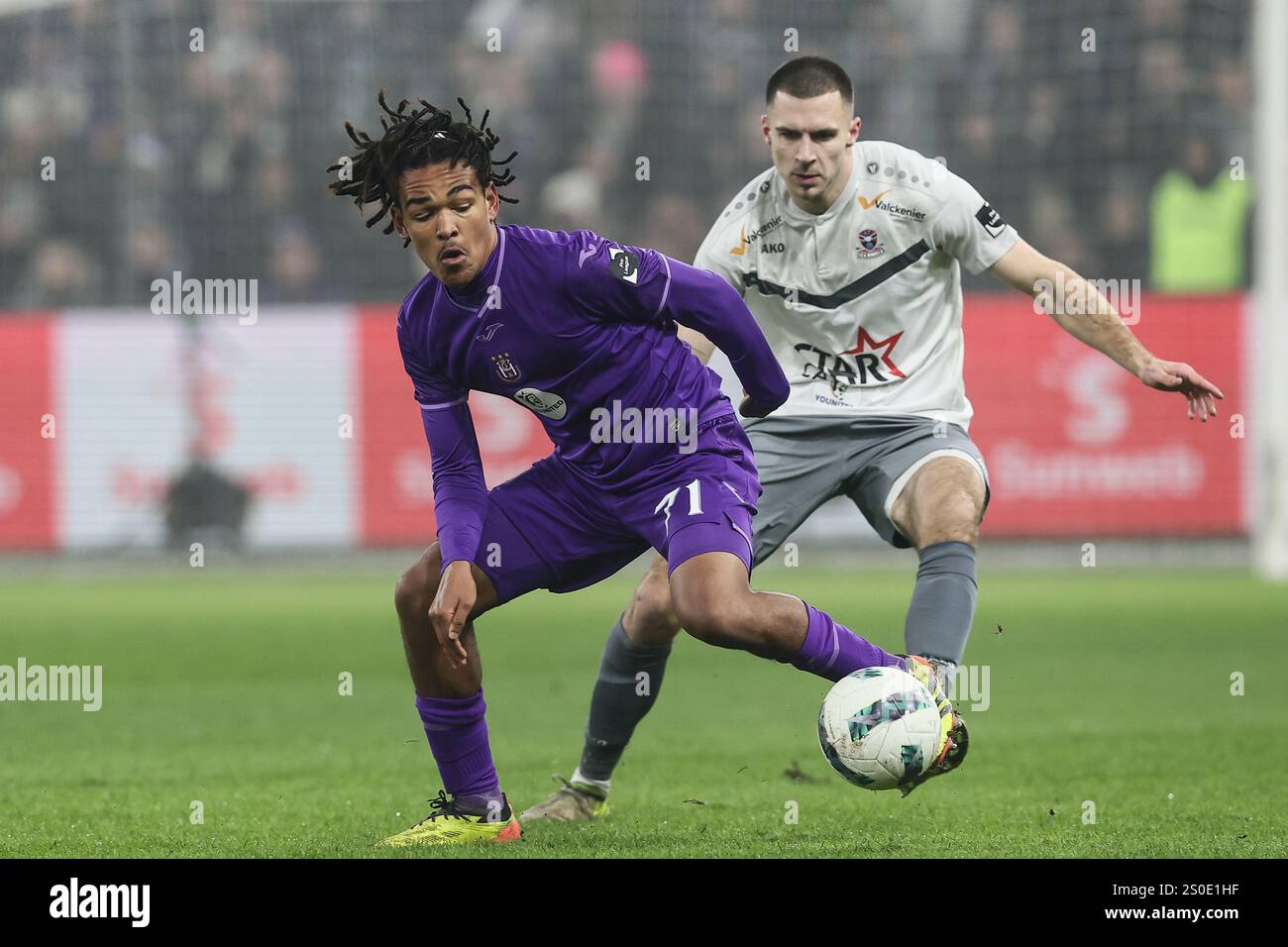Brussels, Belgium. 27th Dec, 2024. Anderlecht's Nzunzio Engwanda and Dender's Joedrick Pupe ...