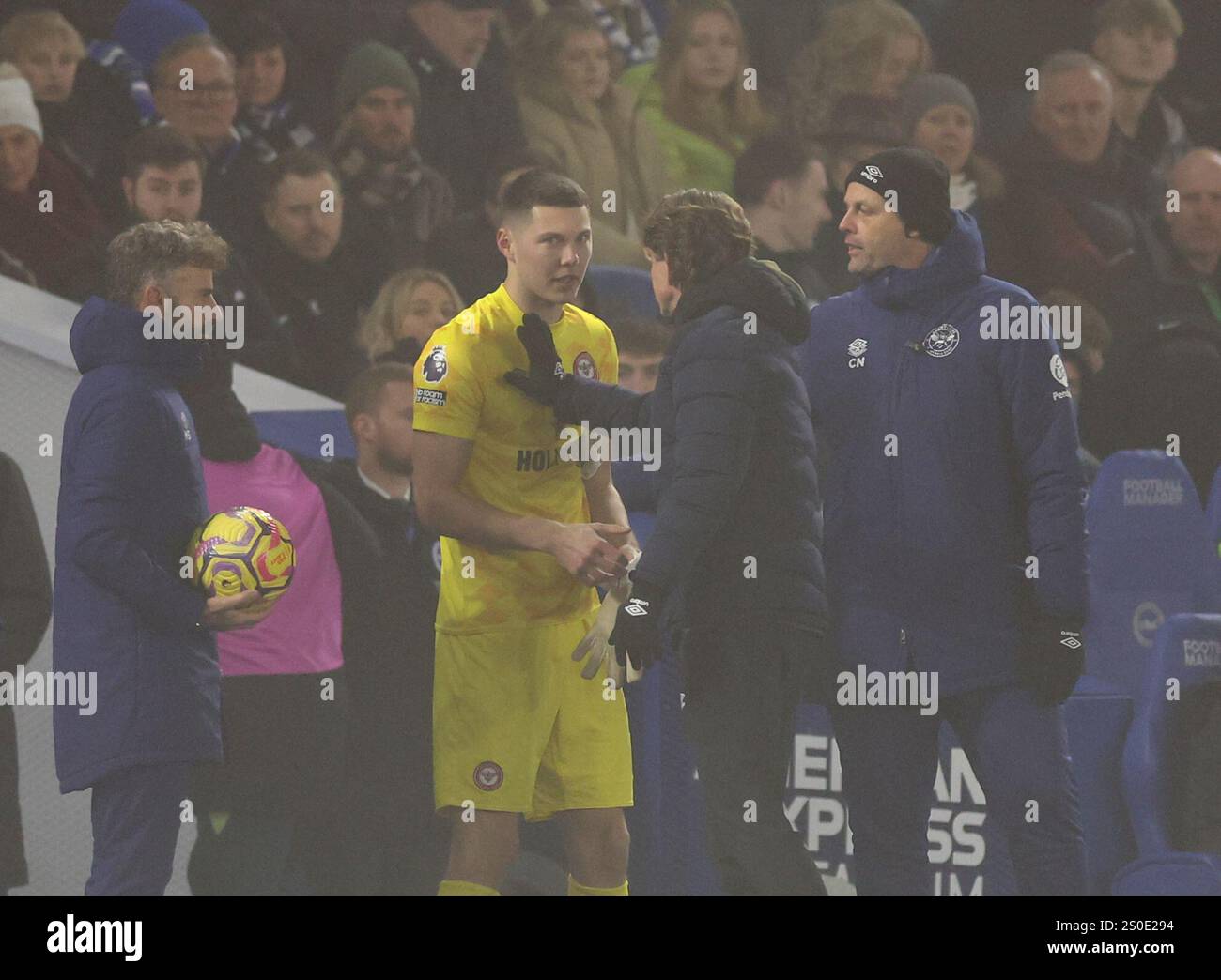 Brentford manager Thomas Frank (right) speaks with substitute ...