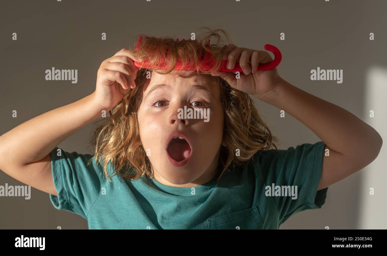 Daily hair care routine. Child with curly hair hold hairbrush or comb ...