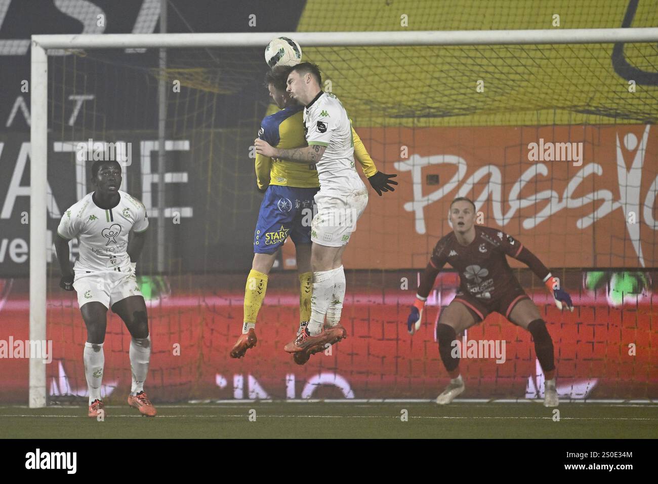 Sint Truiden, Belgium. 27th Dec, 2024. STVV's Isaias Delpupo and Cercle's Gary Magnee fight for ...