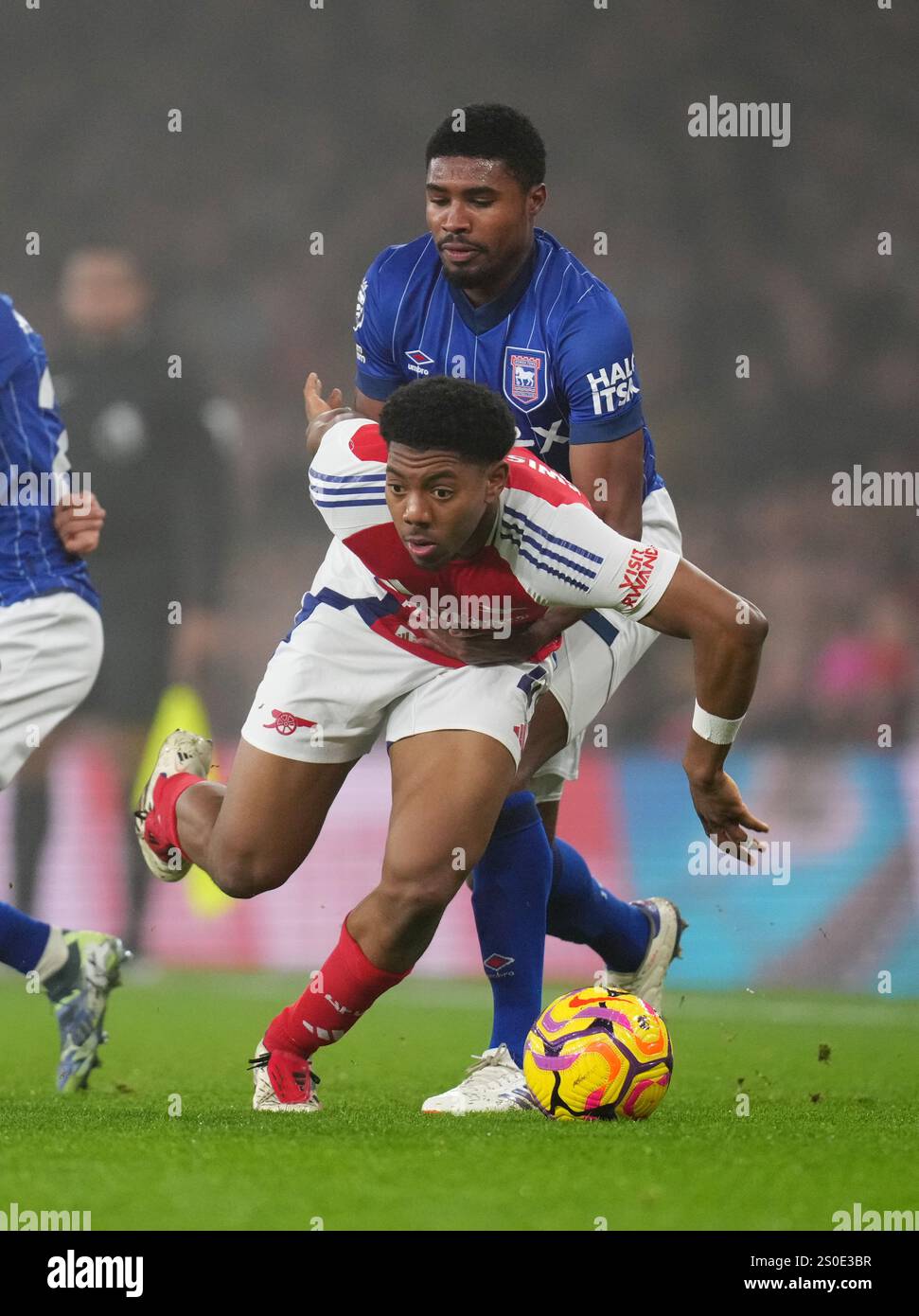 Arsenal's Myles Lewis-Skelly (left) and Ipswich Town's Ben Johnson ...
