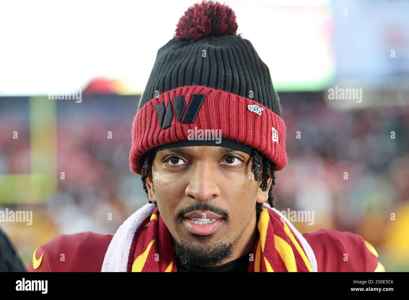 Washington Commanders quarterback Jayden Daniels (5) looks on after an ...