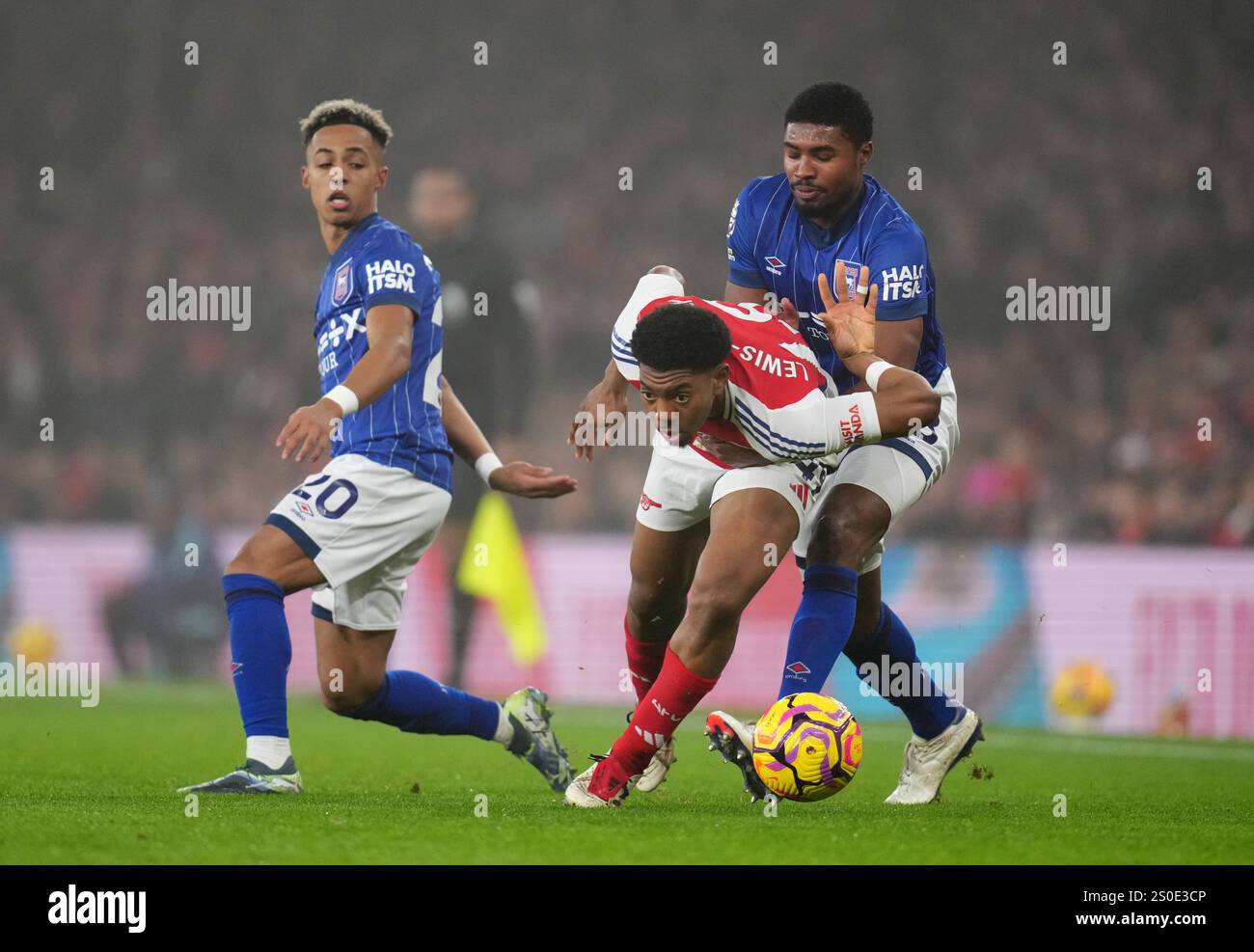 Arsenal's Myles Lewis-Skelly (centre) and Ipswich Town's Ben Johnson ...