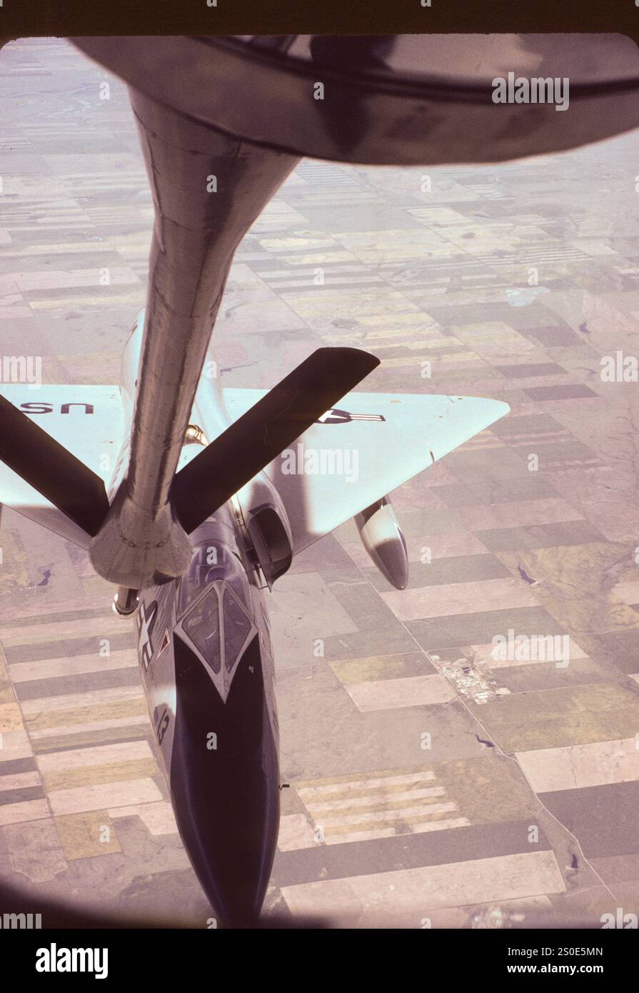 Refueling boom nozzle from KC-135 tanker obscures most of this F-106A ...