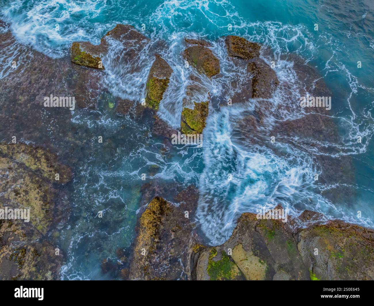 Aerial sunrise seascape looking down at the rocks at The Skillion in Terrigal, NSW, Australia ...