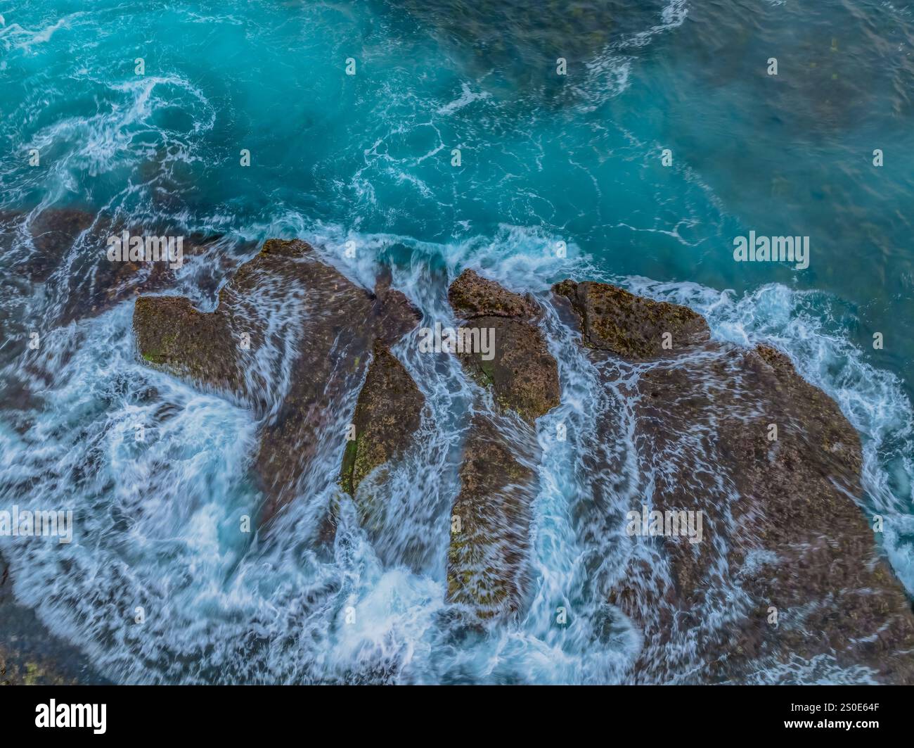 Aerial sunrise seascape looking down at the rocks at The Skillion in Terrigal, NSW, Australia ...