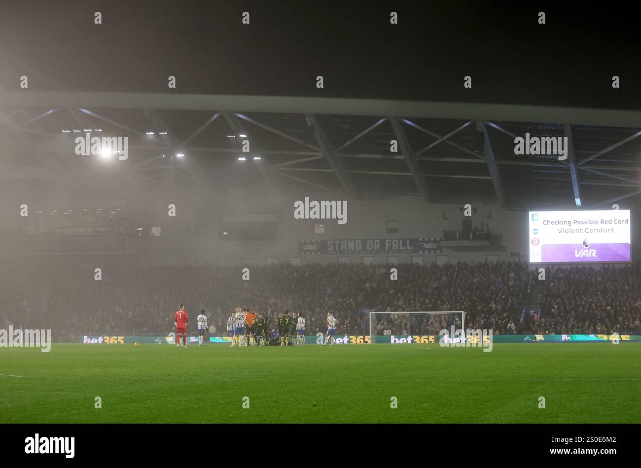 The players from both sides wait for a VAR decision on a red card which ...