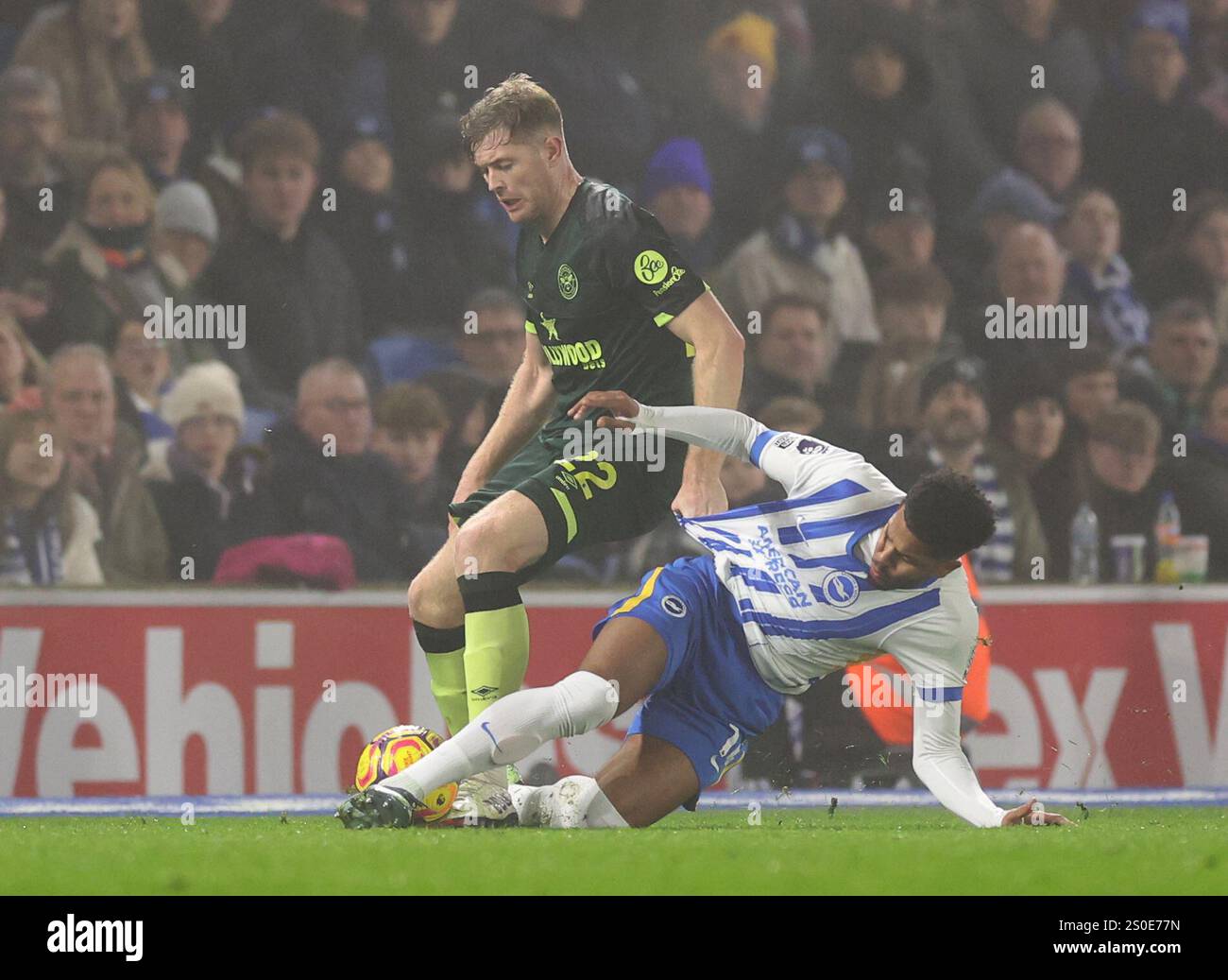 Brentford's Nathan Collins (left) is tackled by Brighton and Hove ...