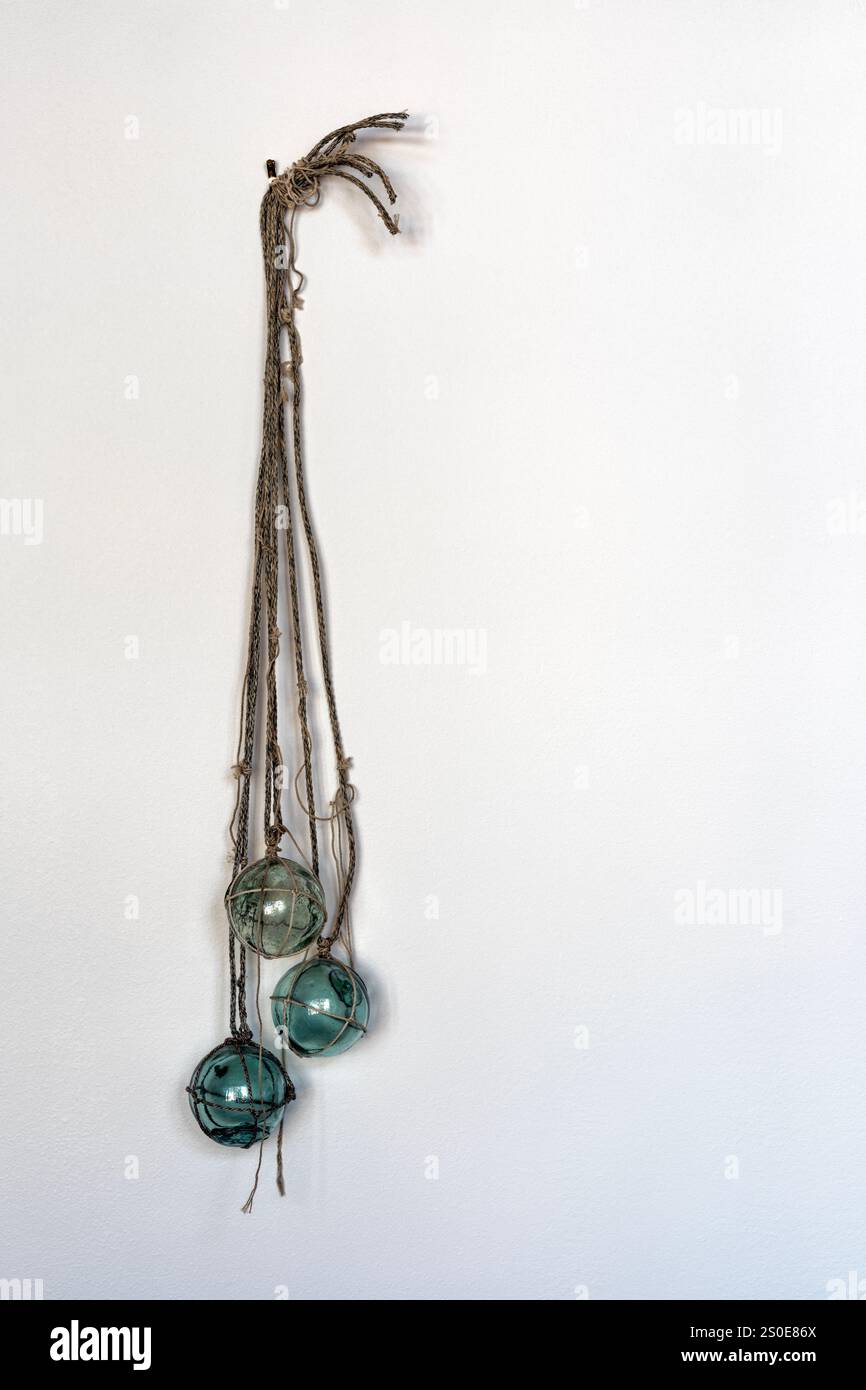 Decorative glass net floats are hanging on an interior wall Stock Photo ...