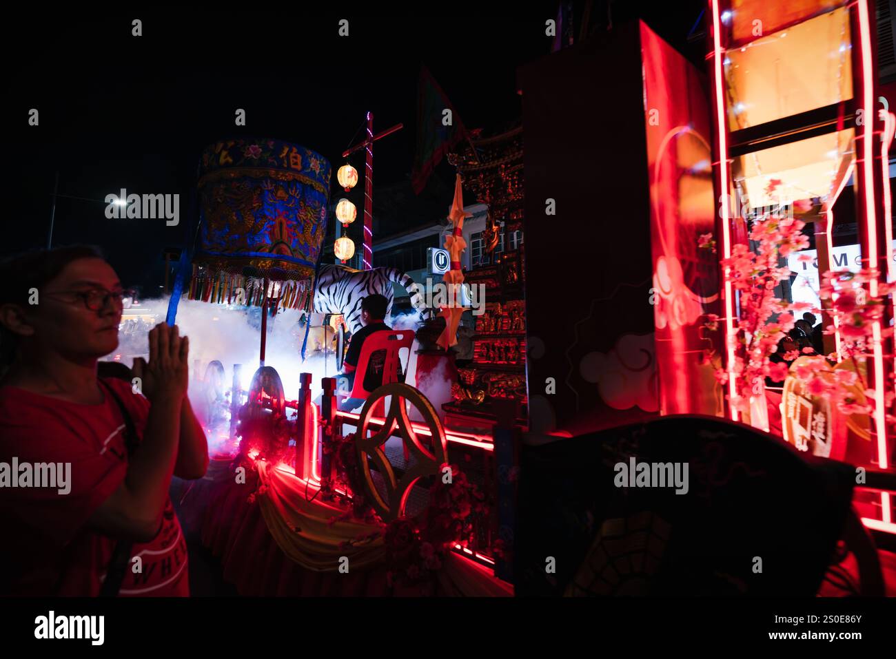 Georgetown, Penang, Malaysia - 24 February 2024: Woman praying for luck ...