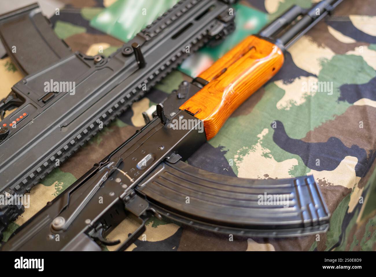 AK-47 Kalashnikov and a modern assault rifle on a camouflage tarp Stock ...