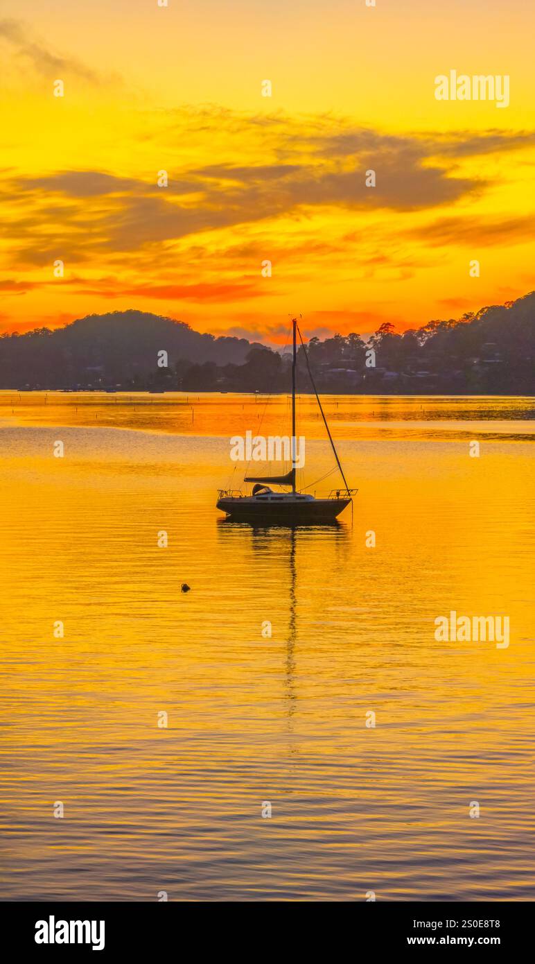 Aerial sunrise waterscape with boats, reflections and some fog around ...