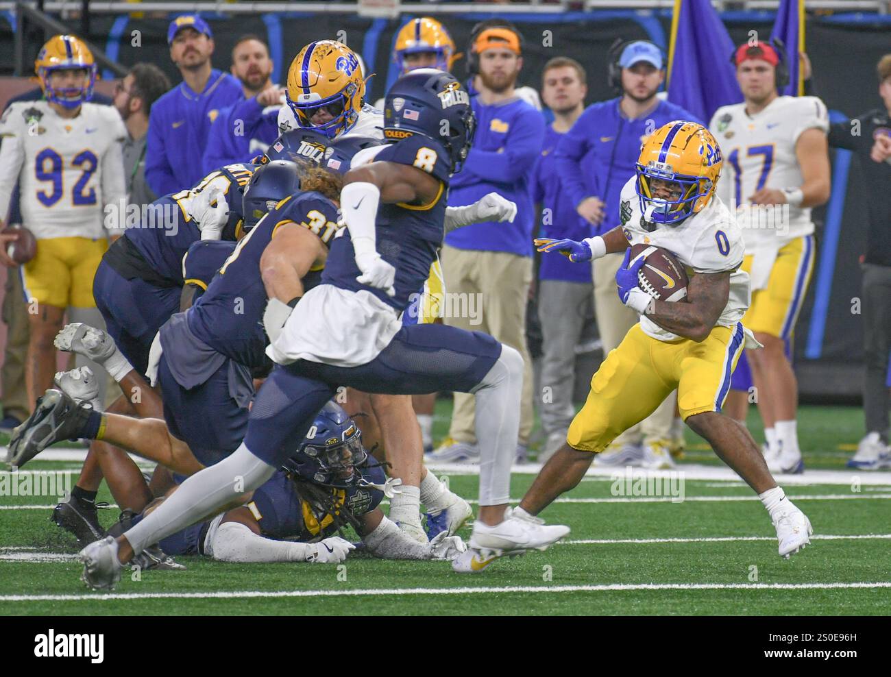 Detroit. 26th Dec, 2024. Toledo Linebacker Lance Dixon (8) tracks down Pitt RB Desmond Reid (0 ...