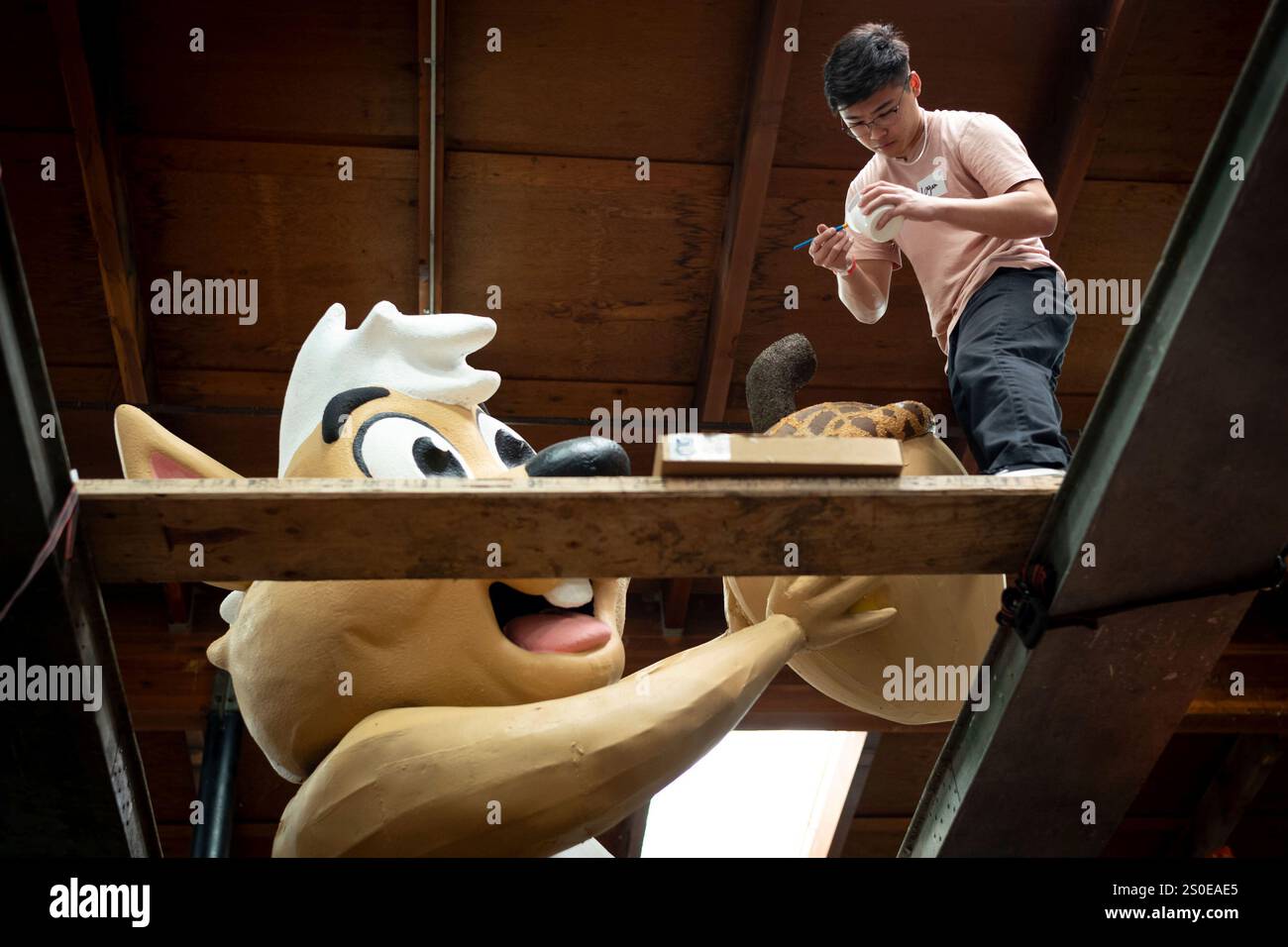 Logan Chung of El Monte applies glue to a squirrel's nut for the "Boys ...