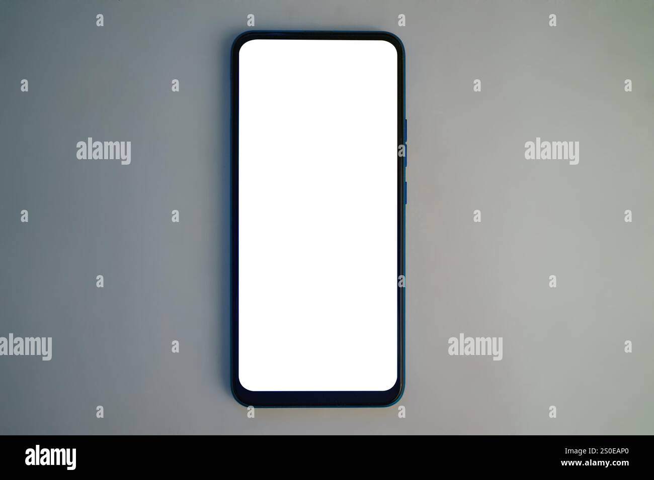 A sleek, modern smartphone lays on a smooth, neutral surface with a ...