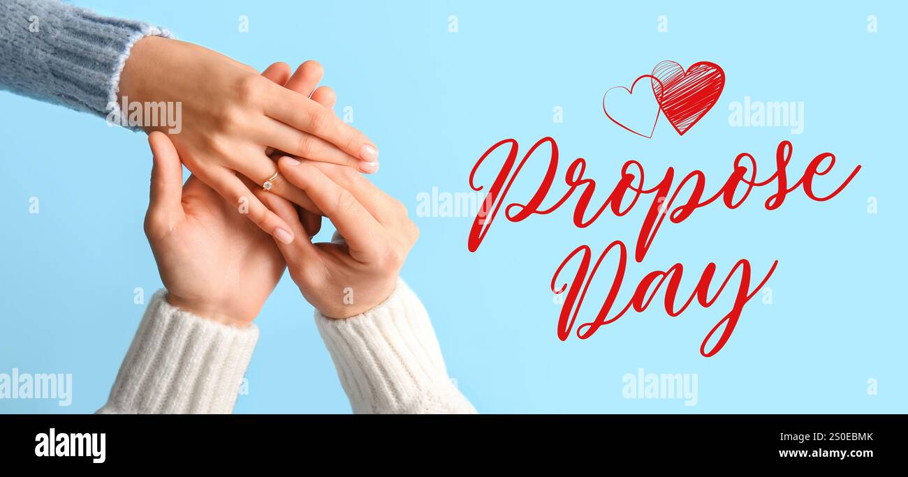 Hands of man putting engagement ring on woman's finger against light ...