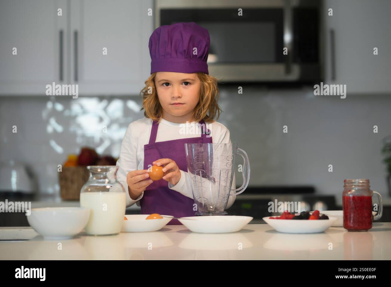 Chef child cooking. Chef child cook baking on the kitchen Stock Photo ...