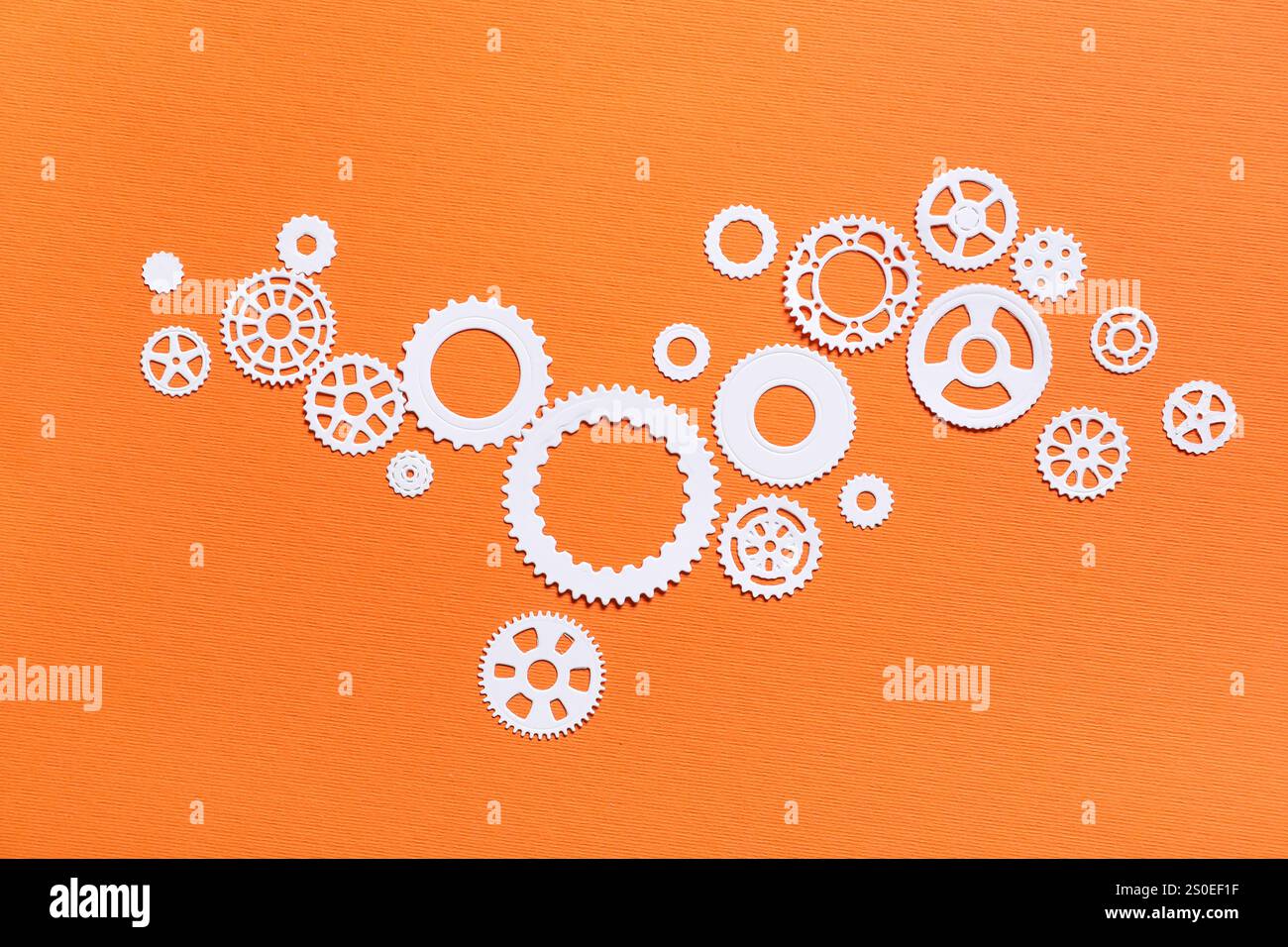 White paper gears on orange background Stock Photo - Alamy