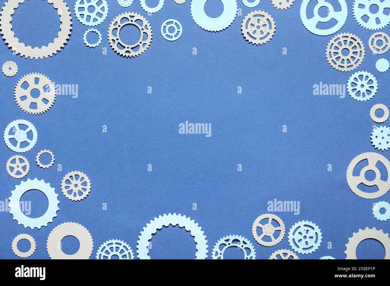Frame made of different paper gears on blue background Stock Photo - Alamy