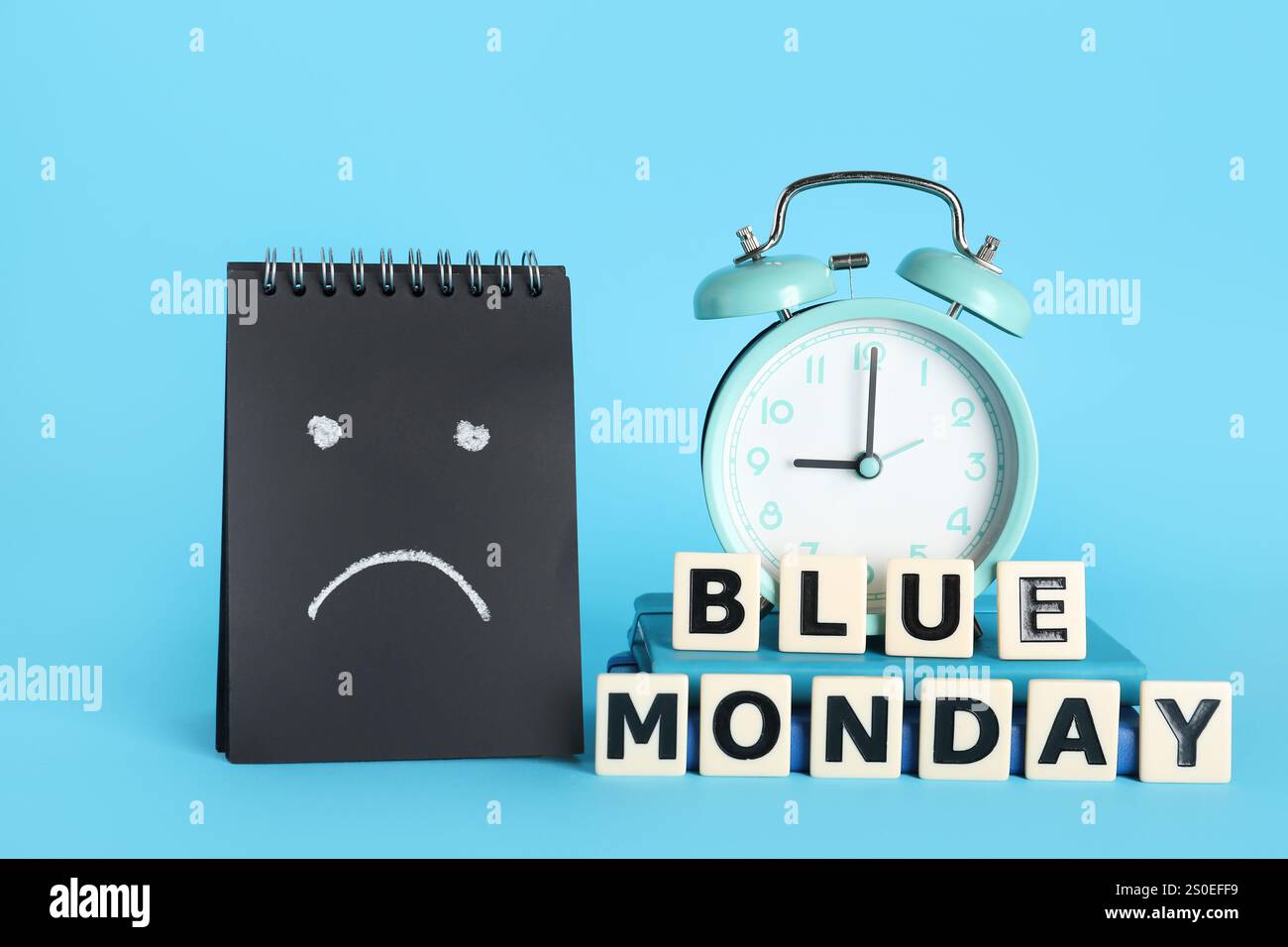 Text BLUE MONDAY, notebook with drawn sad face and alarm clock Stock ...