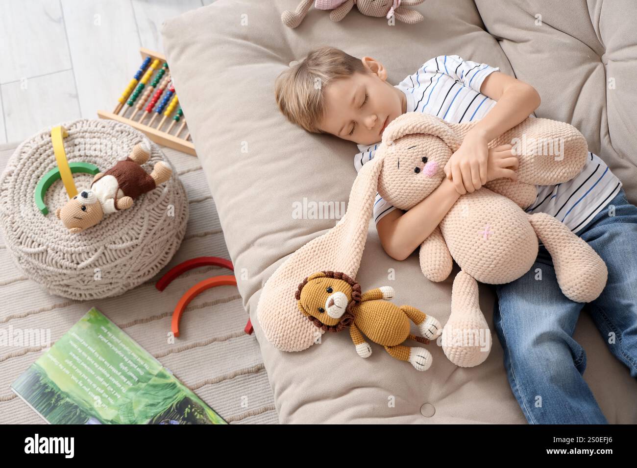 Cute little boy with toys sleeping on sofa at home, top view Stock ...