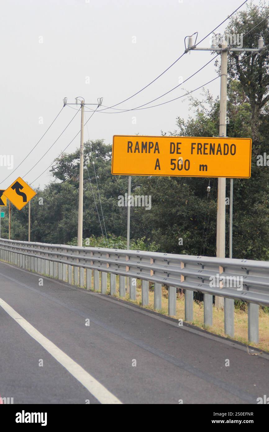 Sign on the highway to indicate a braking ramp to stop vehicles that ...