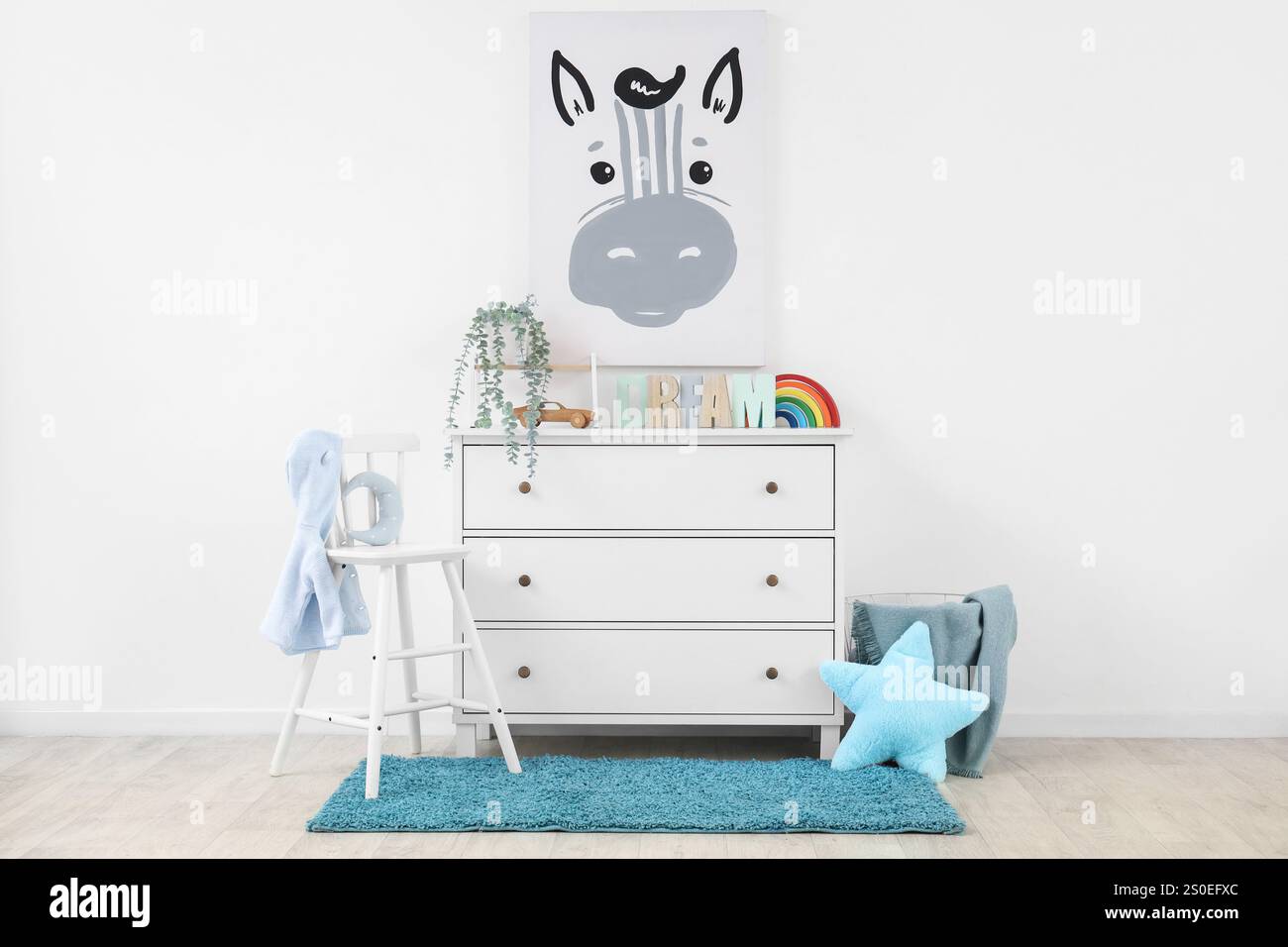Interior of nursery with commode, chair and picture Stock Photo - Alamy