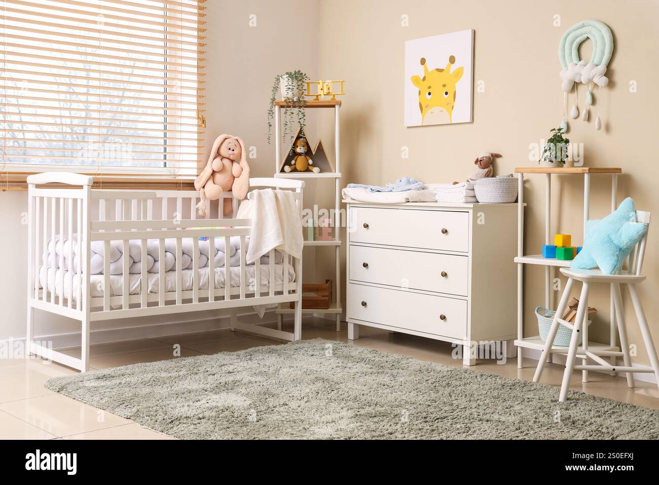 Interior of nursery with commode, crib and shelf units Stock Photo - Alamy