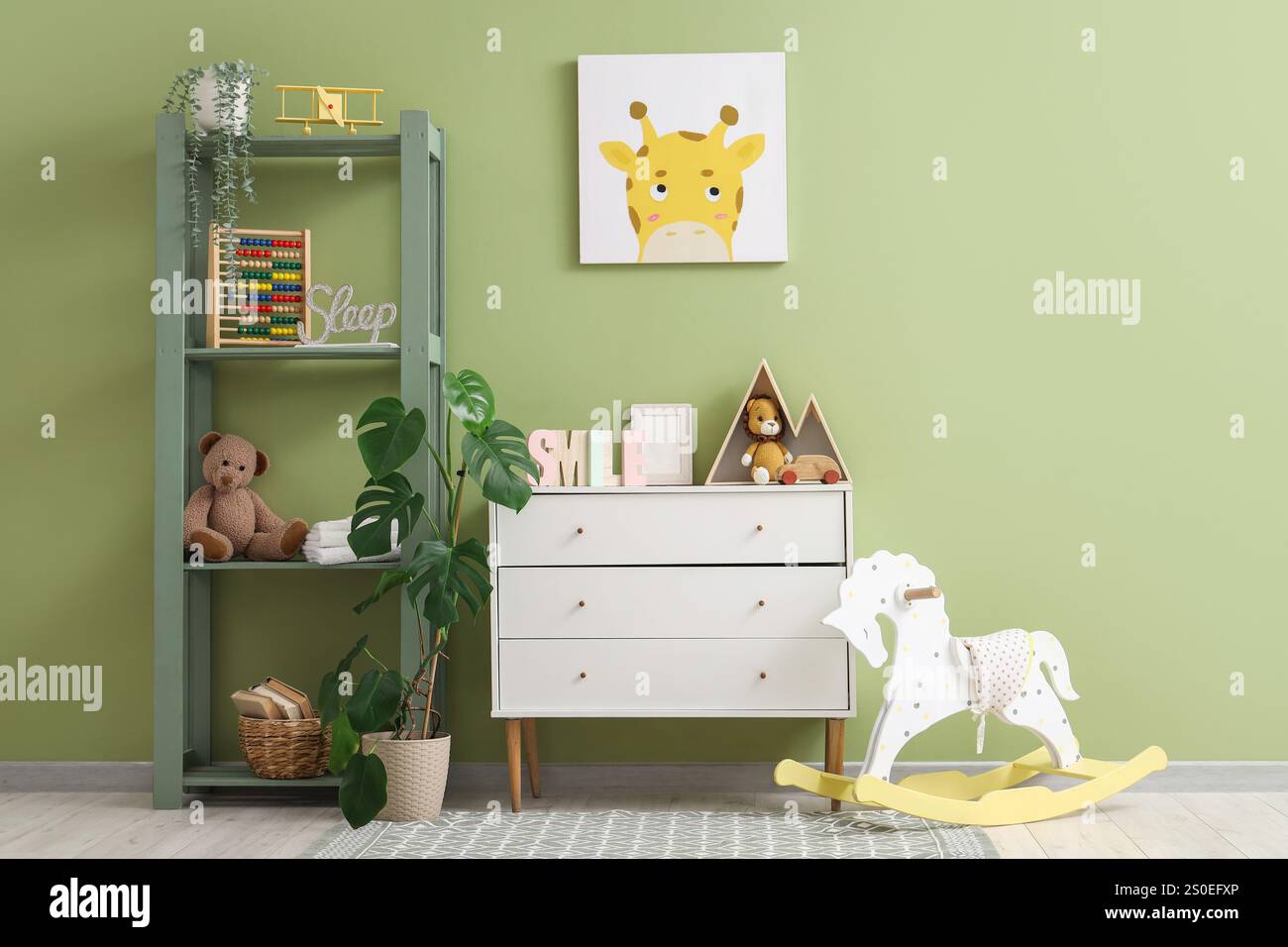 Interior of nursery with commode, shelf unit and toys Stock Photo - Alamy