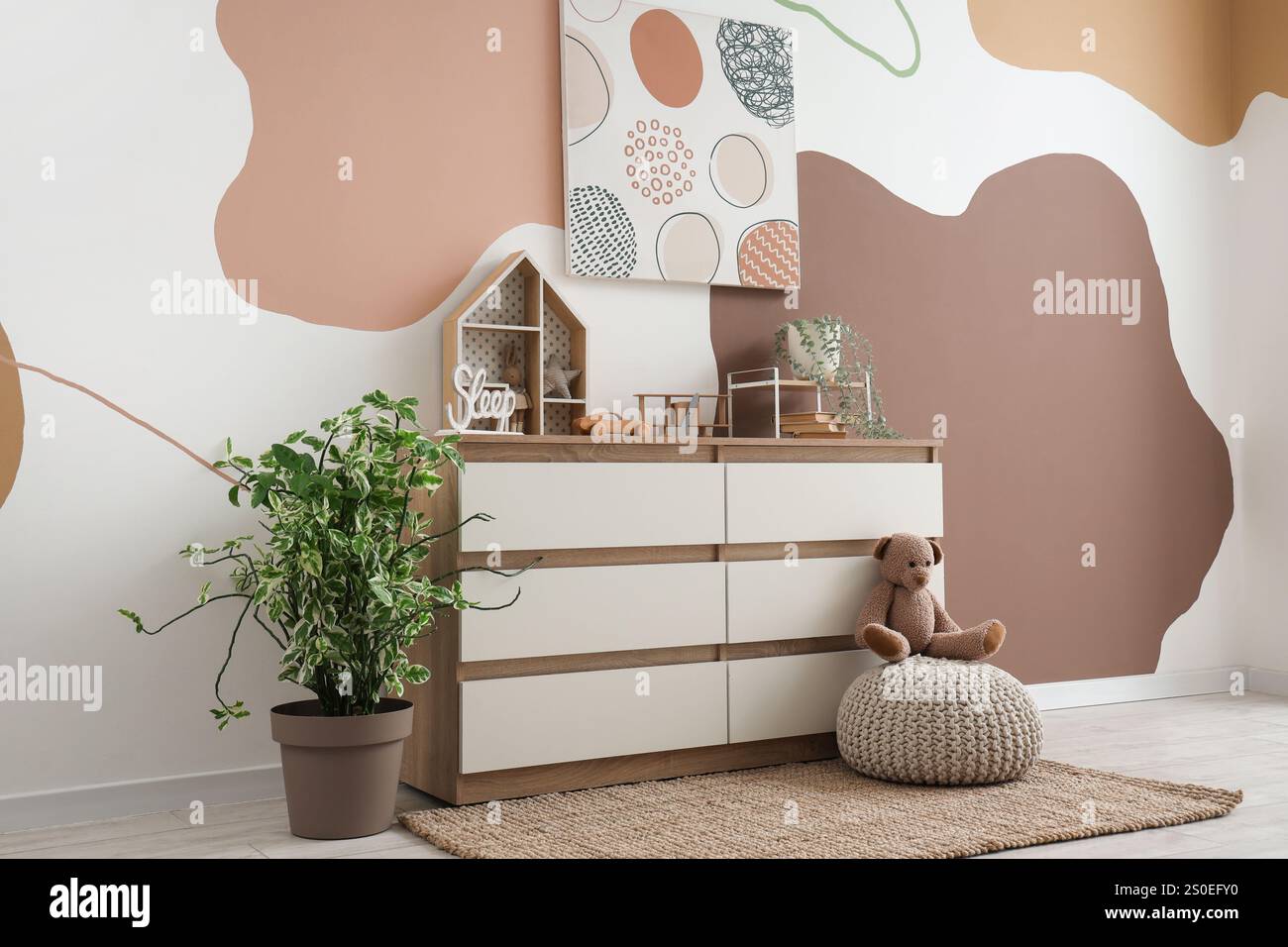 Interior of nursery with commode, painting and toys Stock Photo - Alamy