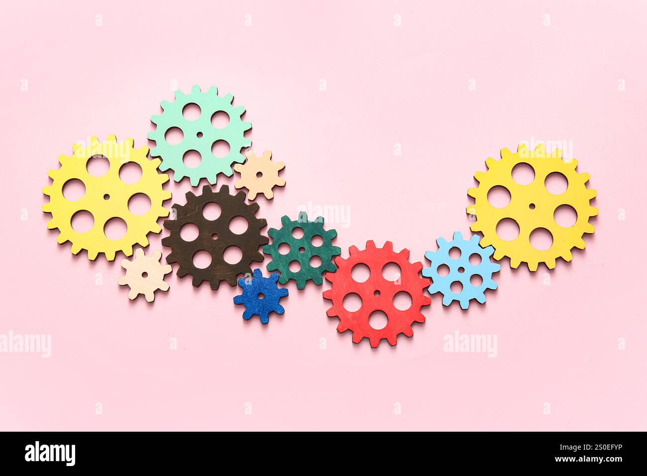 Wooden gears on pink background Stock Photo - Alamy