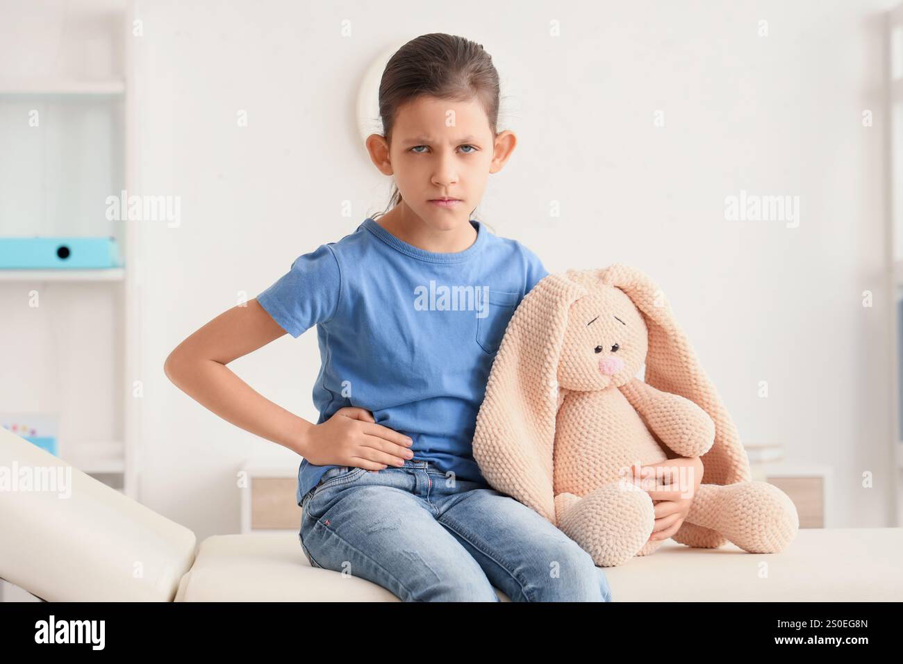 Teenage girl with appendicitis and toy sitting in clinic Stock Photo ...