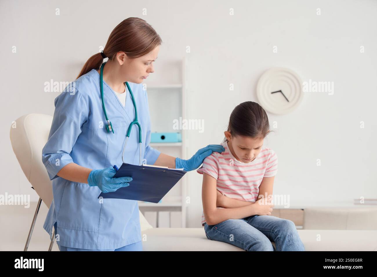 Teenage girl with appendicitis visiting doctor in clinic Stock Photo ...