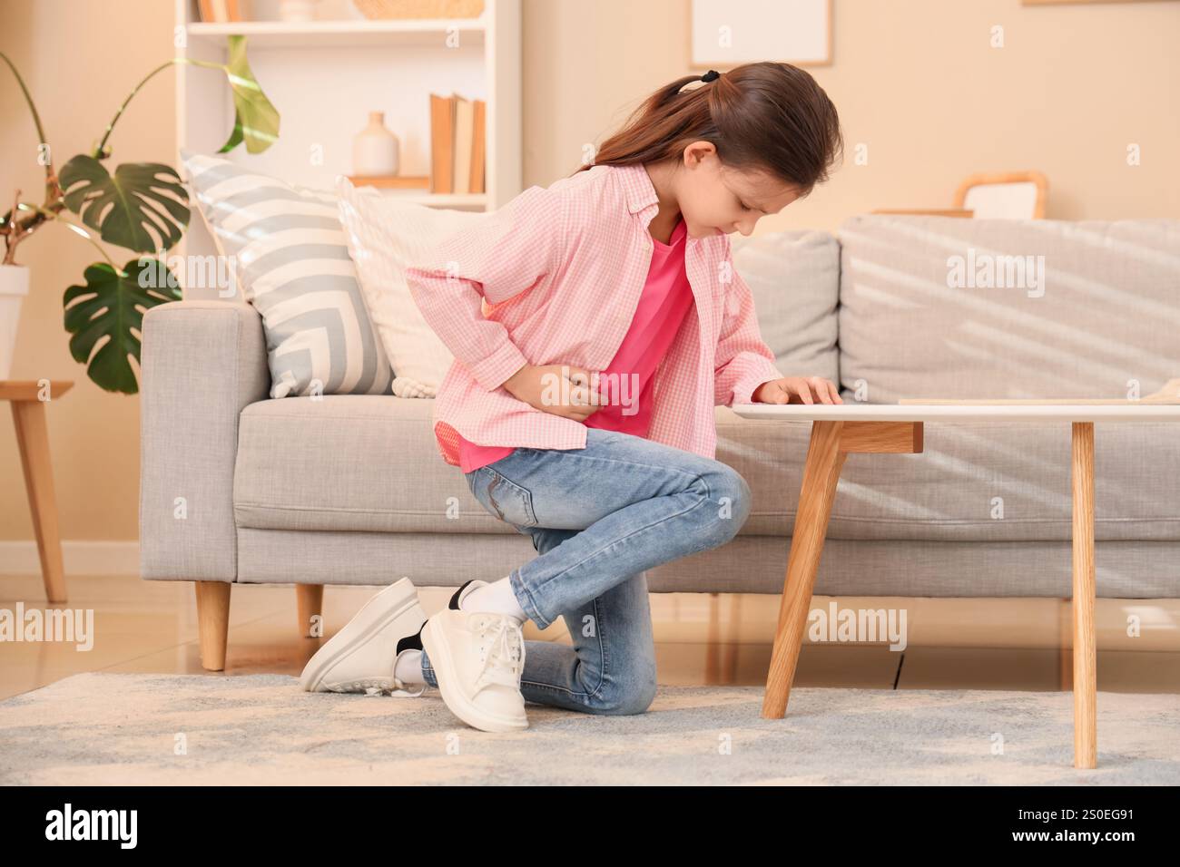 Teenage girl with appendicitis at home Stock Photo - Alamy