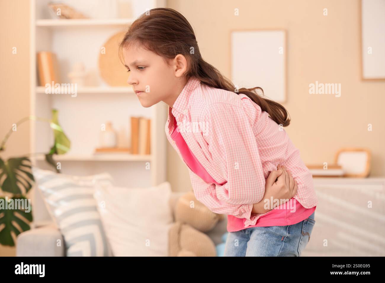 Teenage girl with appendicitis at home Stock Photo - Alamy