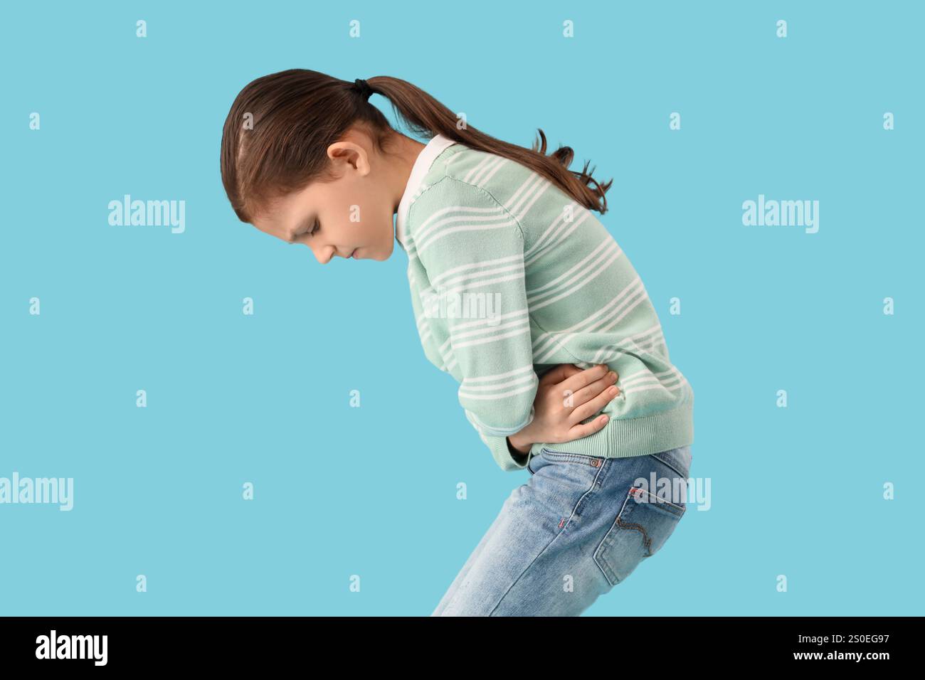Teenage girl with appendicitis on blue background Stock Photo - Alamy