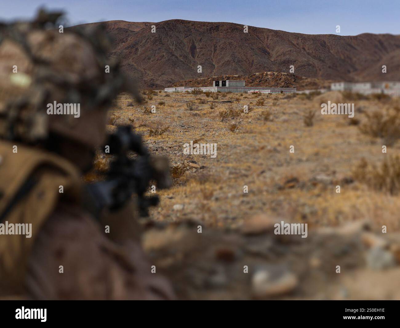 U.S. Marine Corps Cpl. Alexis Lopez fires at simulated adversary forces ...