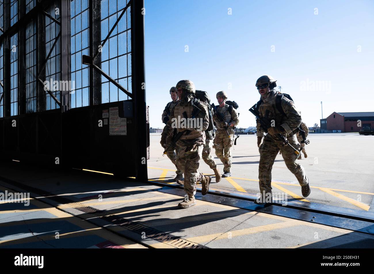 U.S. Air Force Airmen from the 375th Operations Support Squadron cross ...