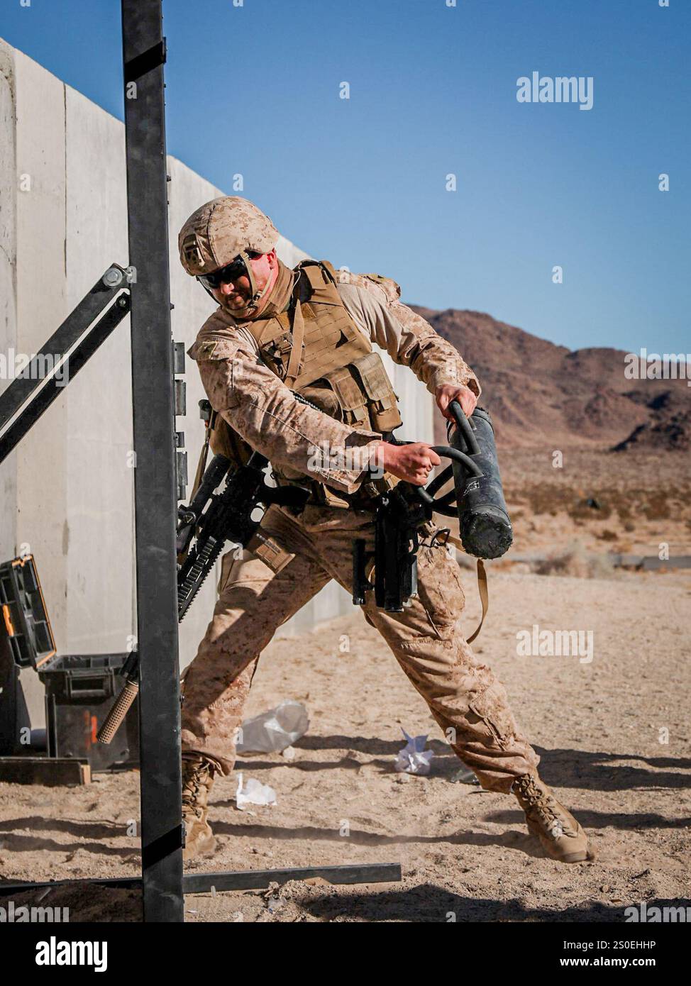 U.S. Marine Corps Lance Cpl. James Subera breaches an entrance for a ...