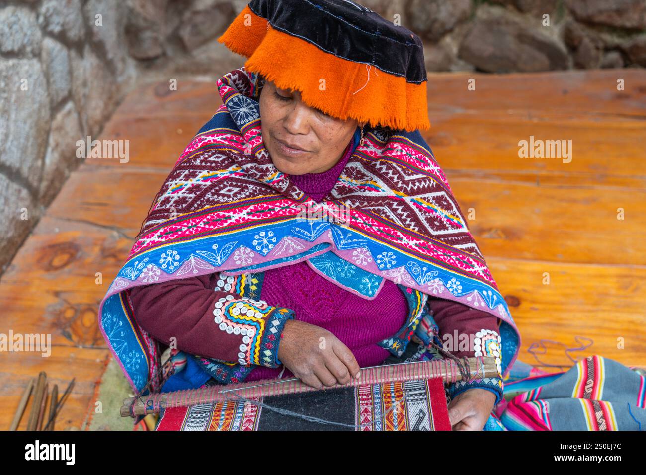 A Peruvian Woman Weaves Textiles on a Loom using Traditional Techniques ...